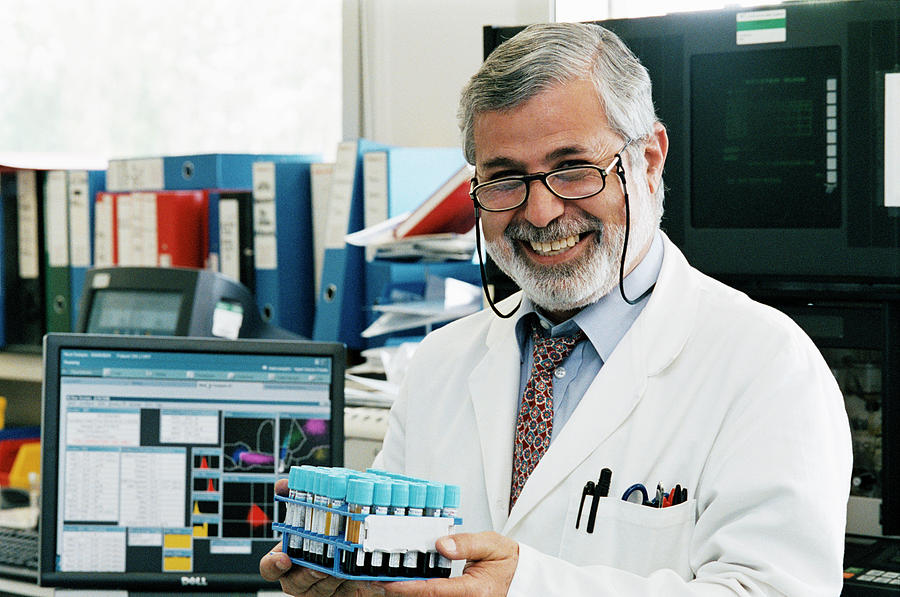 Pathologist Holding Blood Samples by Mark Thomas / Science Photo Library