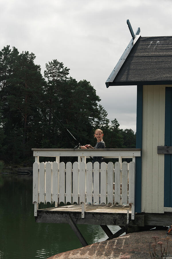 Girl Fishing By The Sea From A Traditional Swedish Hut Photograph by ...