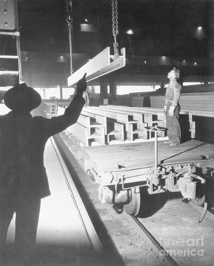 Men Loading Steel Beams Onto R.r. Car by Bettmann