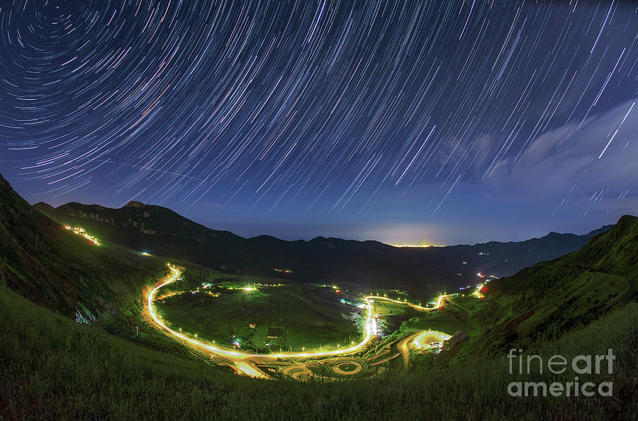 Star Trails Over A Road by Amirreza Kamkar / Science Photo Library